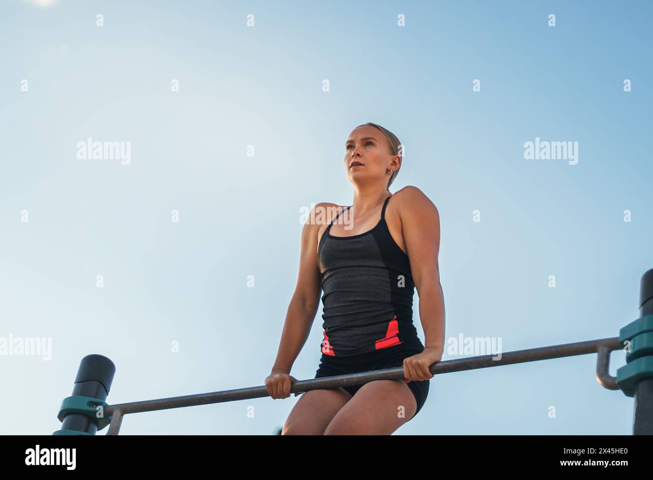 woman athlete doing dips on a bar outdoors. calisthenics Stock Photo ...