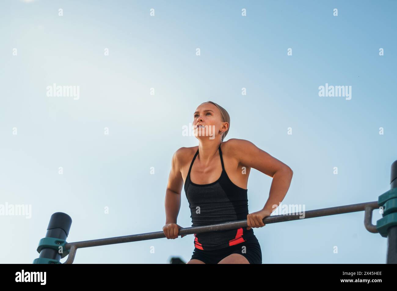 woman athlete doing dips on a bar outdoors. calisthenics Stock Photo ...
