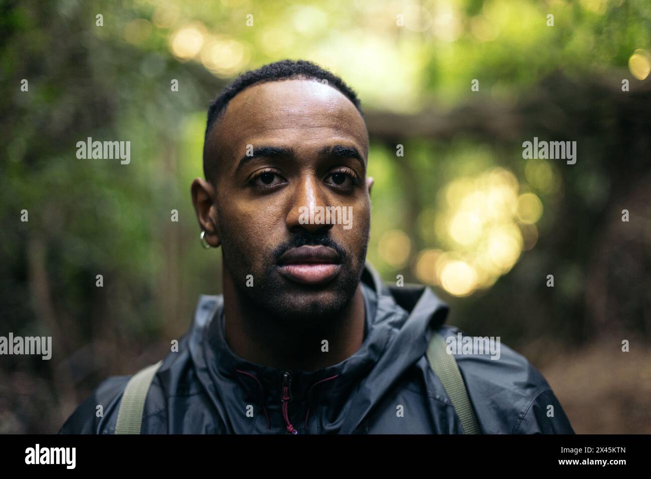 Portrait of an African American man looking at camera with intense gaze ...
