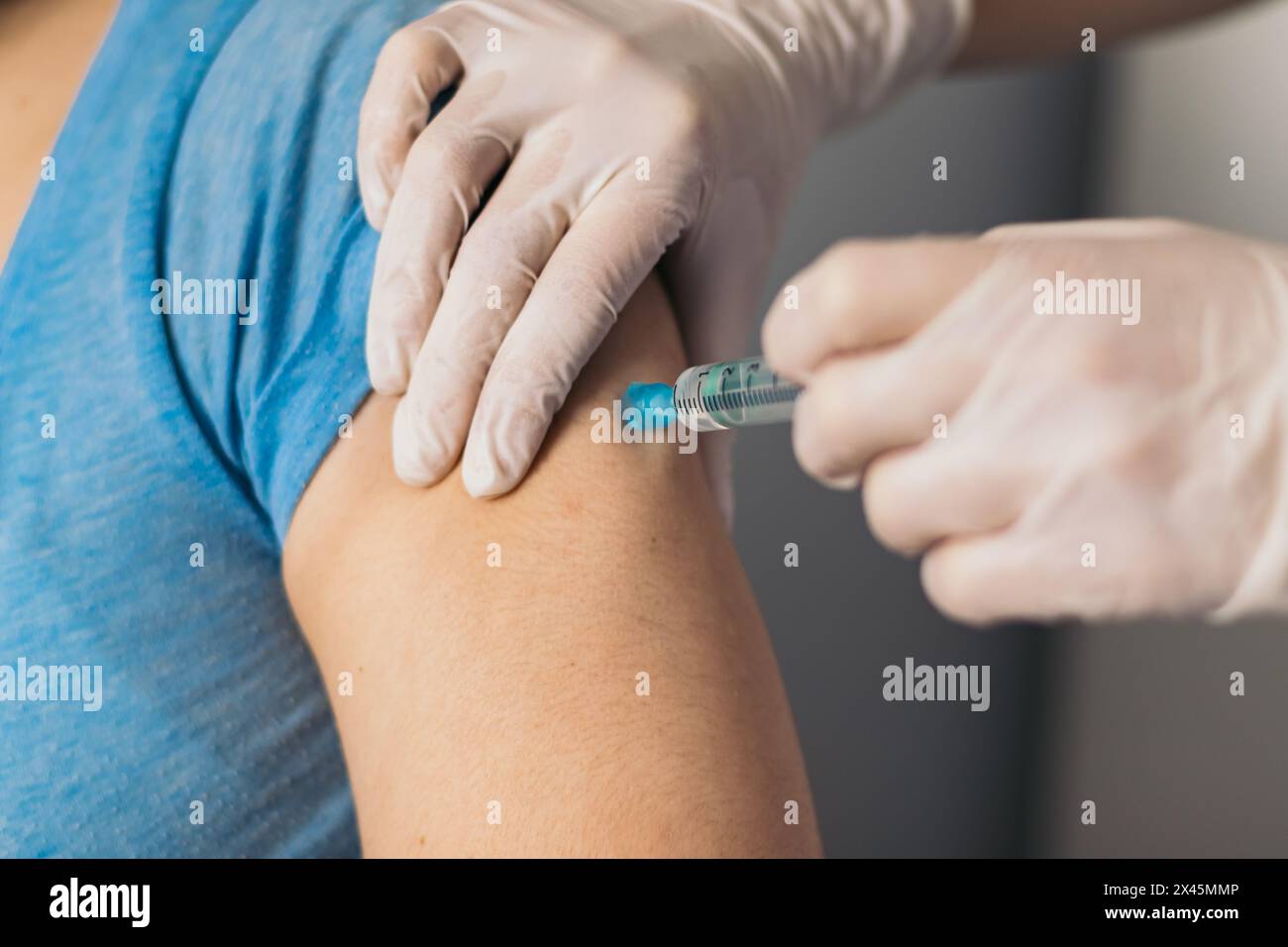 Doctor hands injecting vaccine in the arm of a patient Stock Photo - Alamy