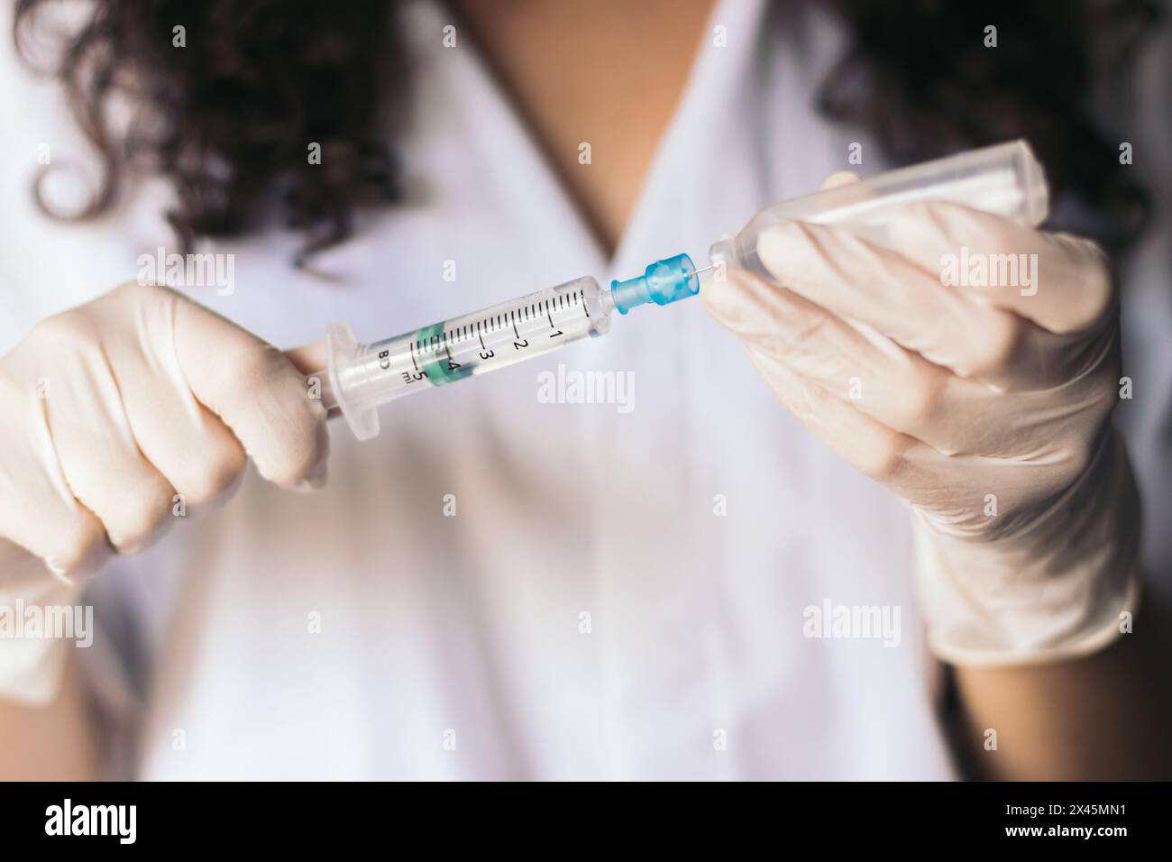 Nurse with syringe and serum Stock Photo - Alamy