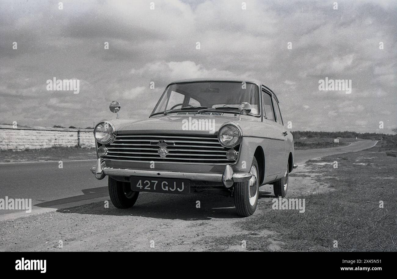 1960s, historical, an Austin A40 car of the era parked beside an A road ...