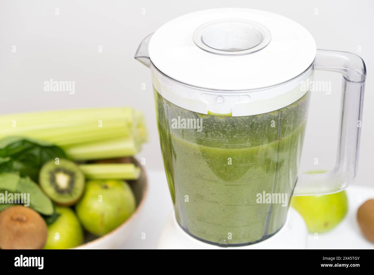 Cooking vegetable fruit smoothie in blender, process of grinding ...