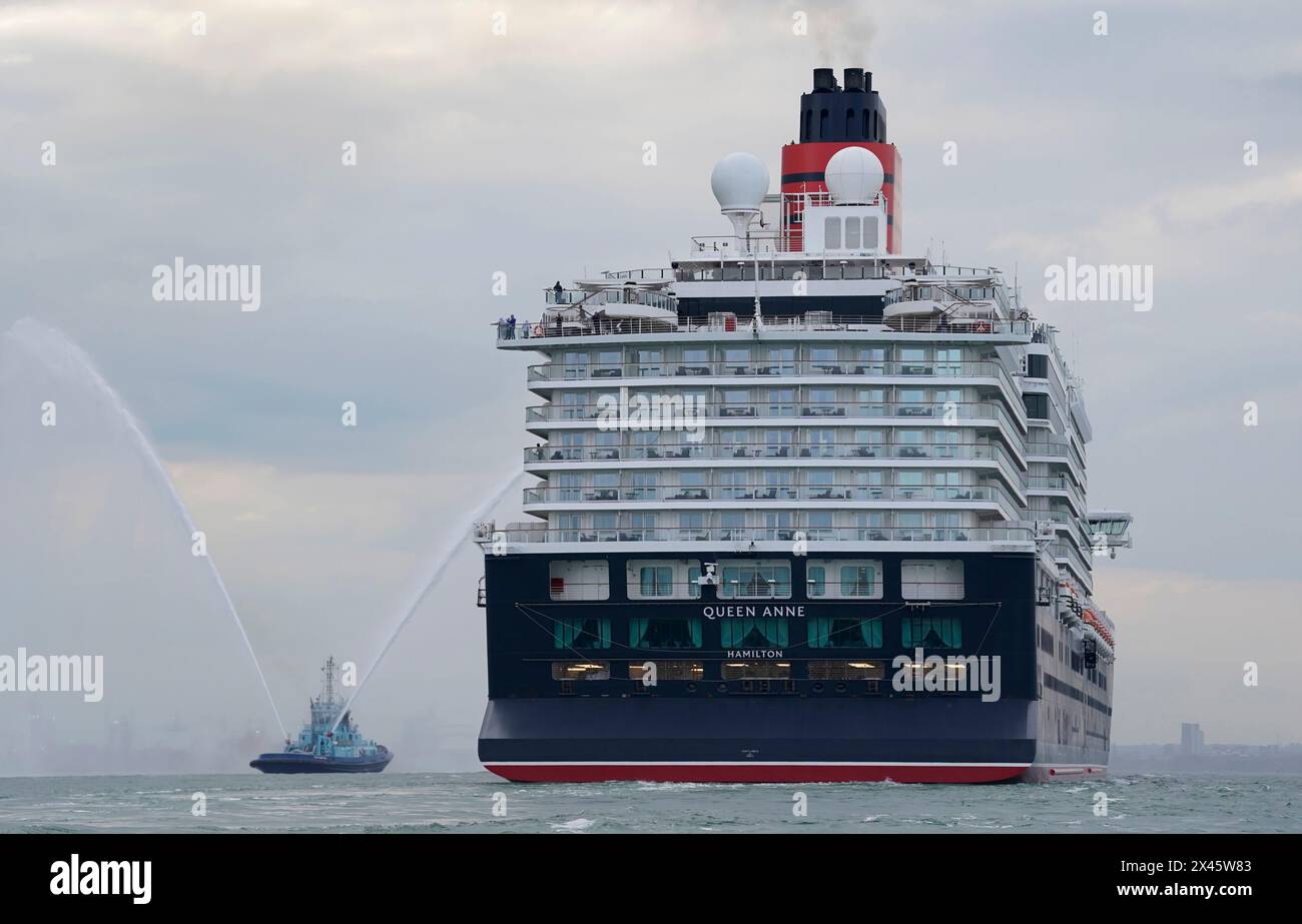 A tug boat sprays water as Cunard's newest cruise ship Queen Anne ...