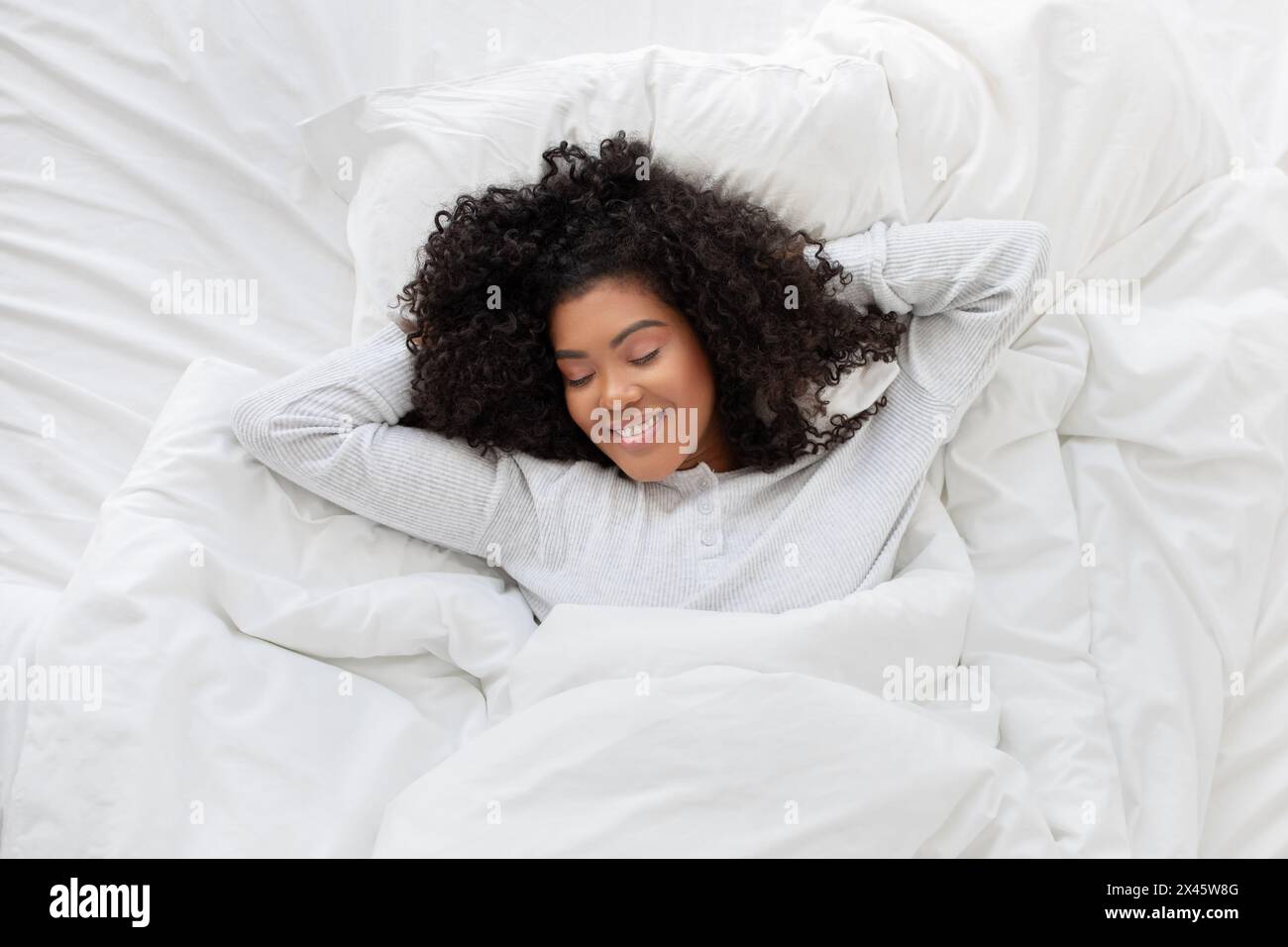 Woman Laying in Bed With White Sheets, Smiling Stock Photo - Alamy