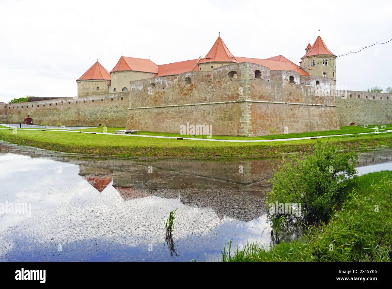 Romanian fortress Fagaras and its reflection in the waters of the moat ...