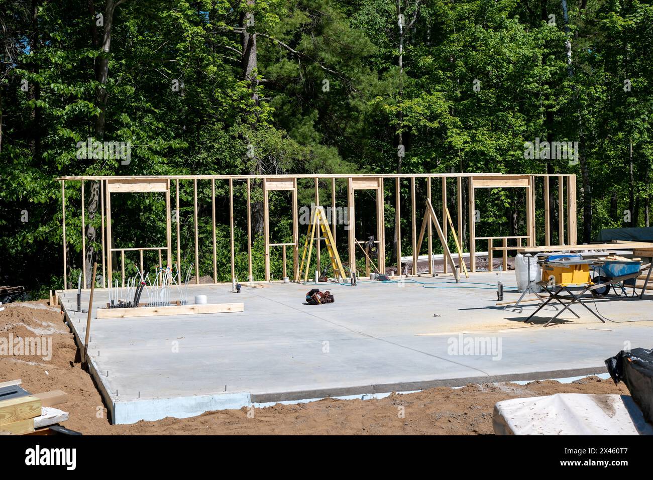 New home construction site with wood studs of first wall in place, and ...