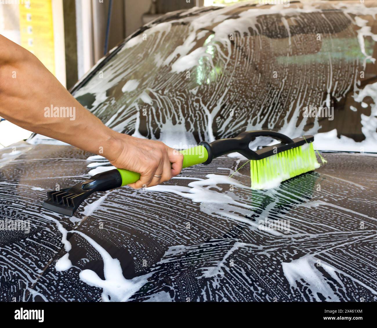 The car undergoes a thorough cleaning with high pressure water in an ...