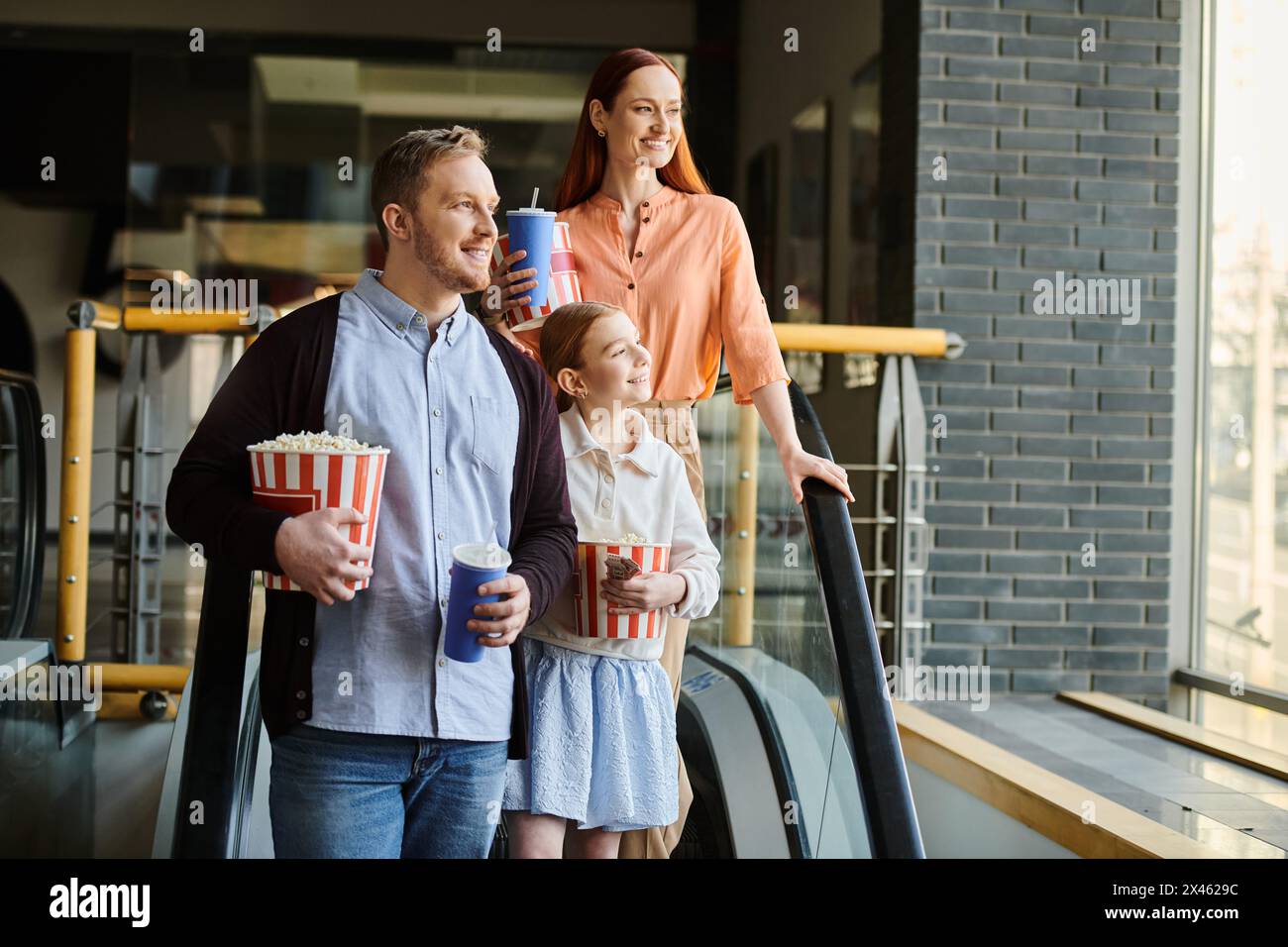A man and his family happily walk down the escalator, enjoying their time together as a family ...
