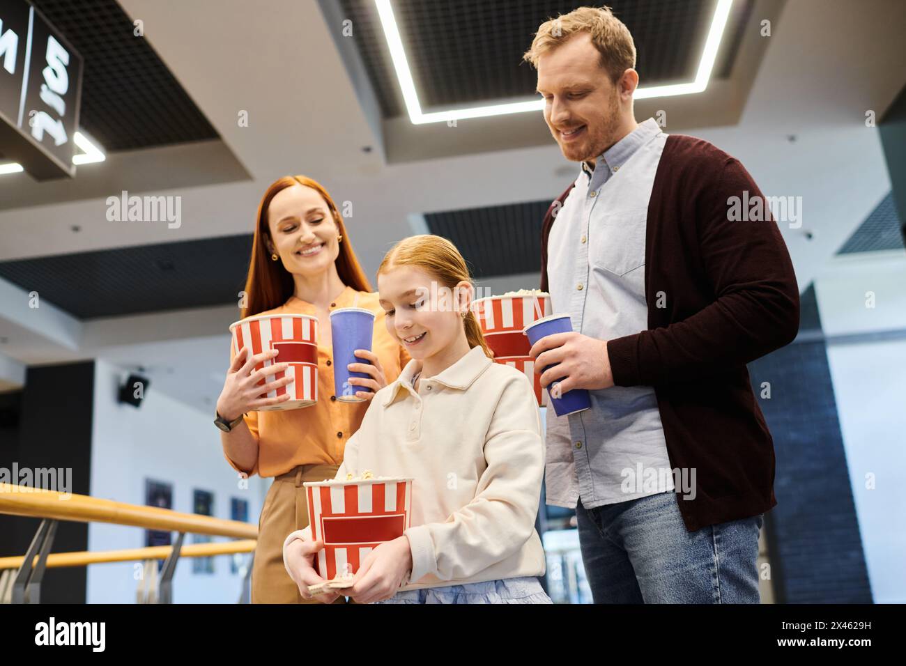A man and wife with kid joyfully hold cups of coffee, bonding over ...