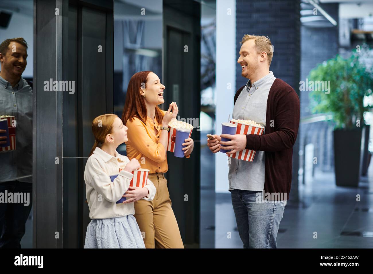 A happy family stands closely together, forming a tight circle of love ...