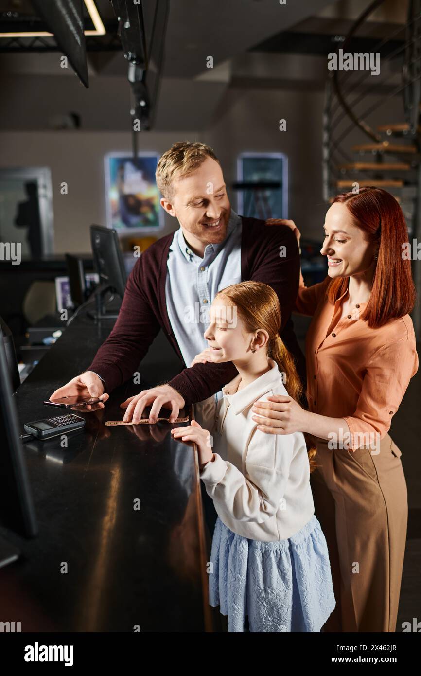 family engage with a computer, sharing smiles and laughter in a bonding ...