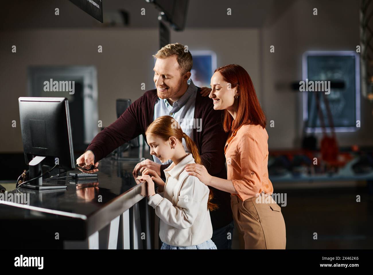 Family gathered around computer hi-res stock photography and images - Alamy