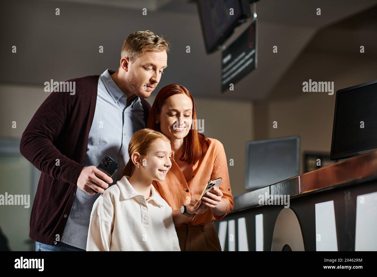 family engrossed in a cell phone, sharing a moment of modern ...