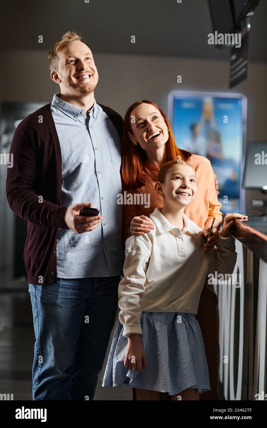 A man, woman, and child stand together, enjoying the view and each ...