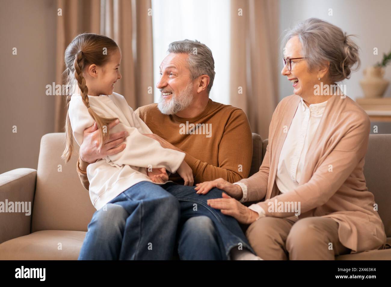 Joyful Grandparents Enjoying Quality Time With Their Granddaughter ...