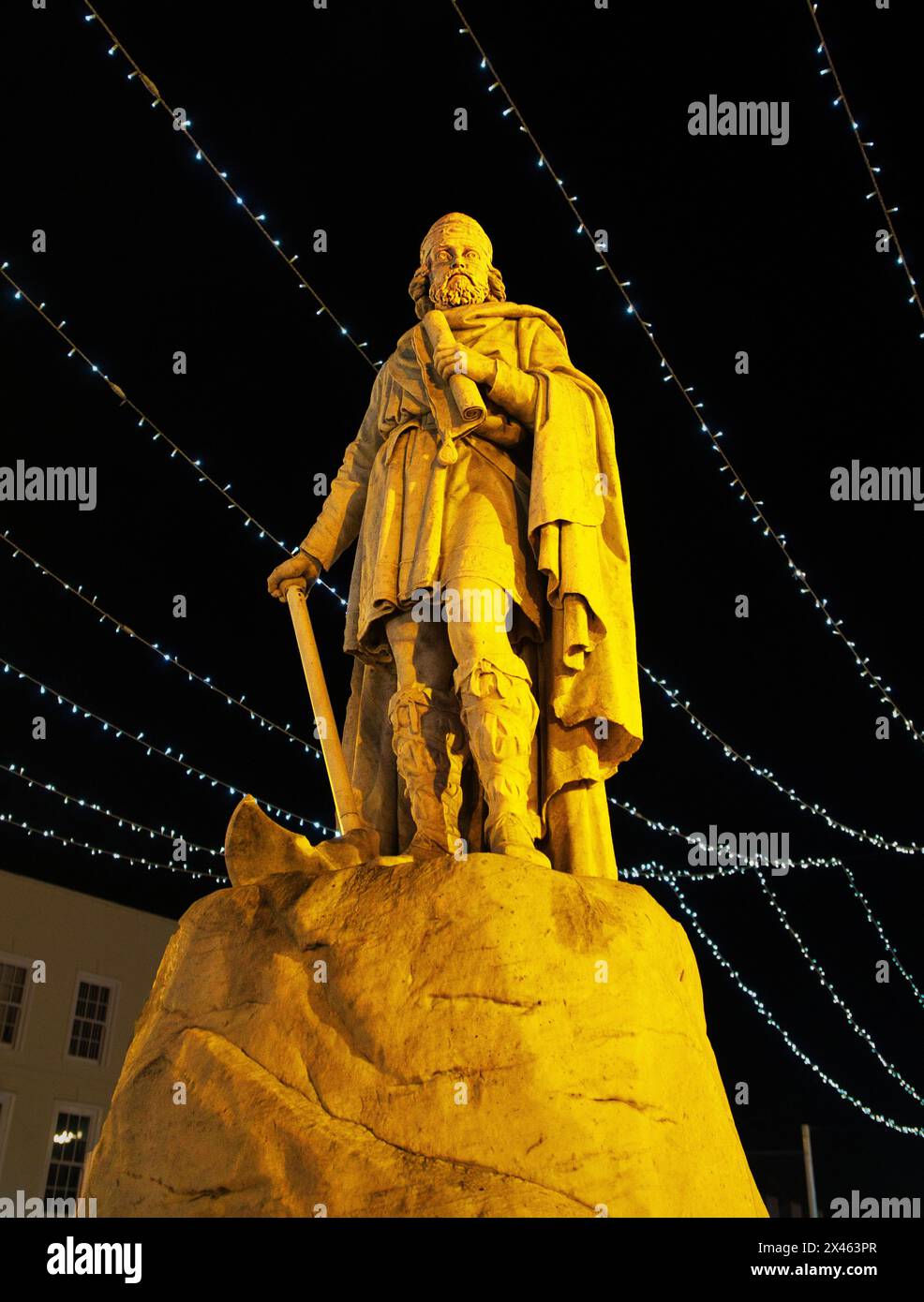 Stone statue of King Arthur illuminated in the Market Place, Wantage ...
