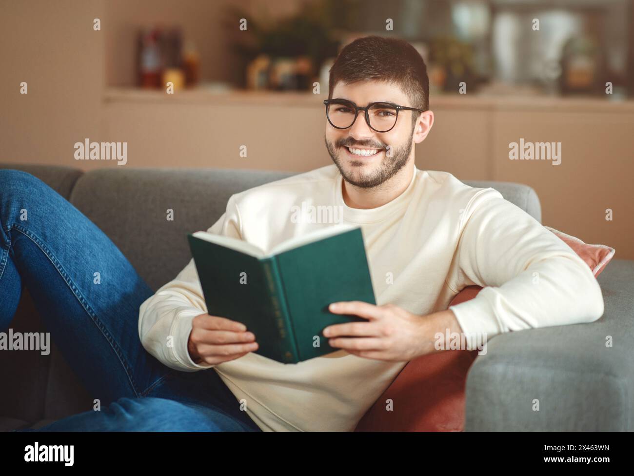 Absorbed man reading book sitting hi-res stock photography and images ...