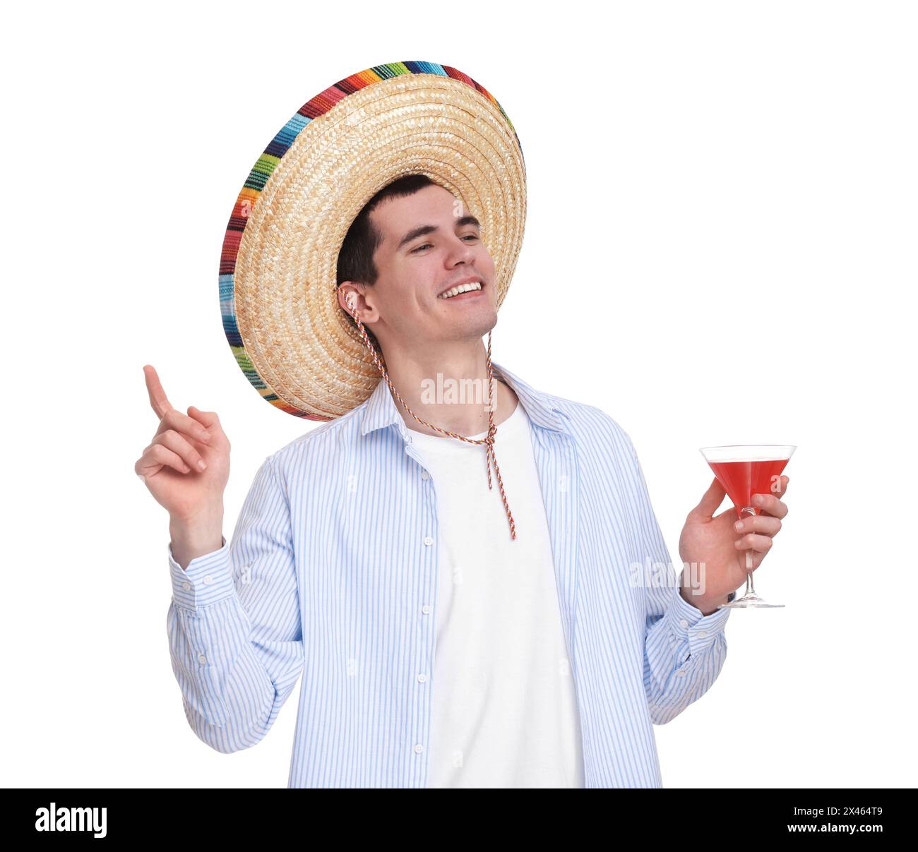 Young man in Mexican sombrero hat with cocktail on white background ...