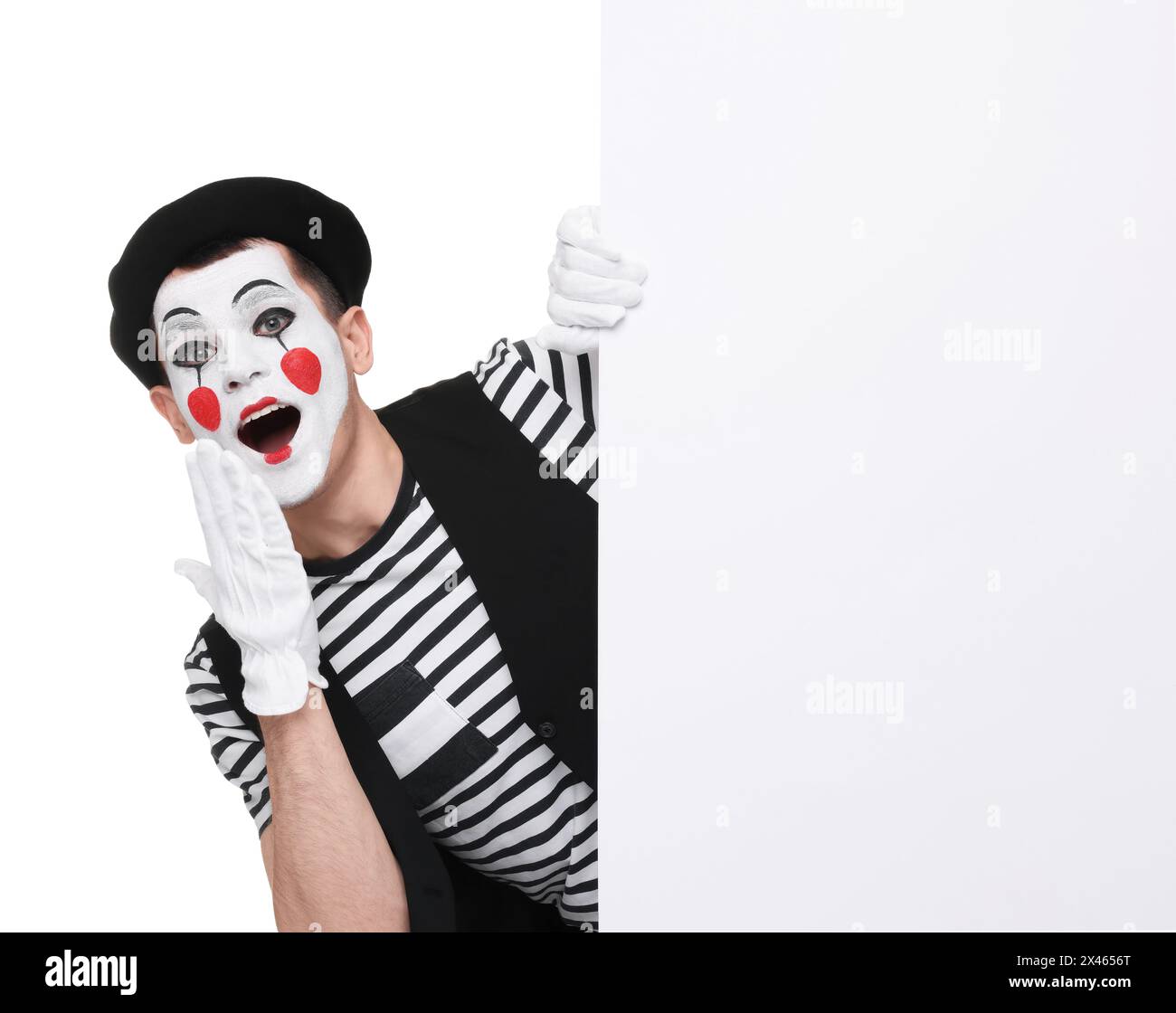 Funny mime artist peeking out of blank poster on white background Stock ...