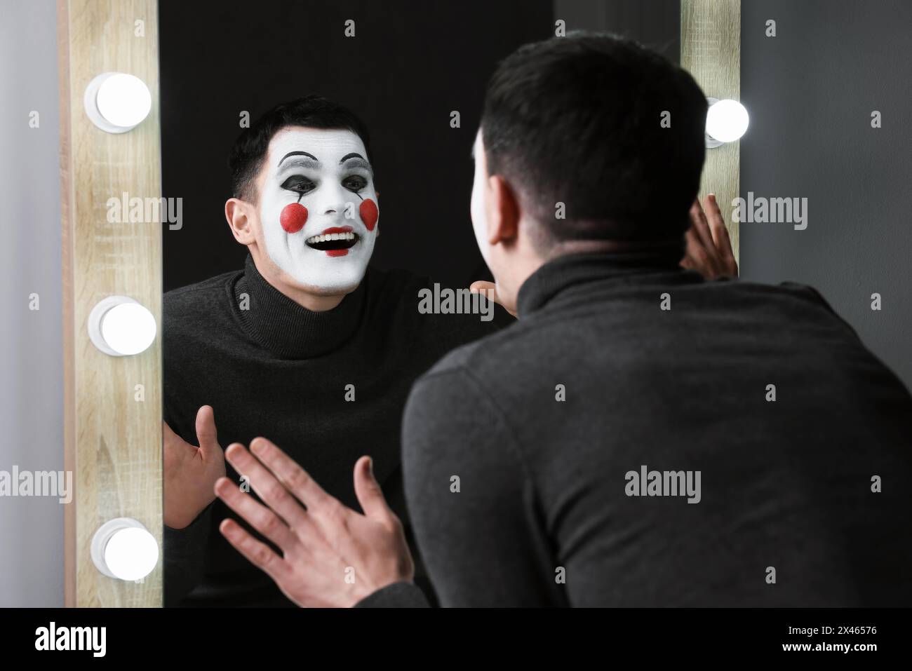 Mime artist posing near mirror in dressing room Stock Photo - Alamy