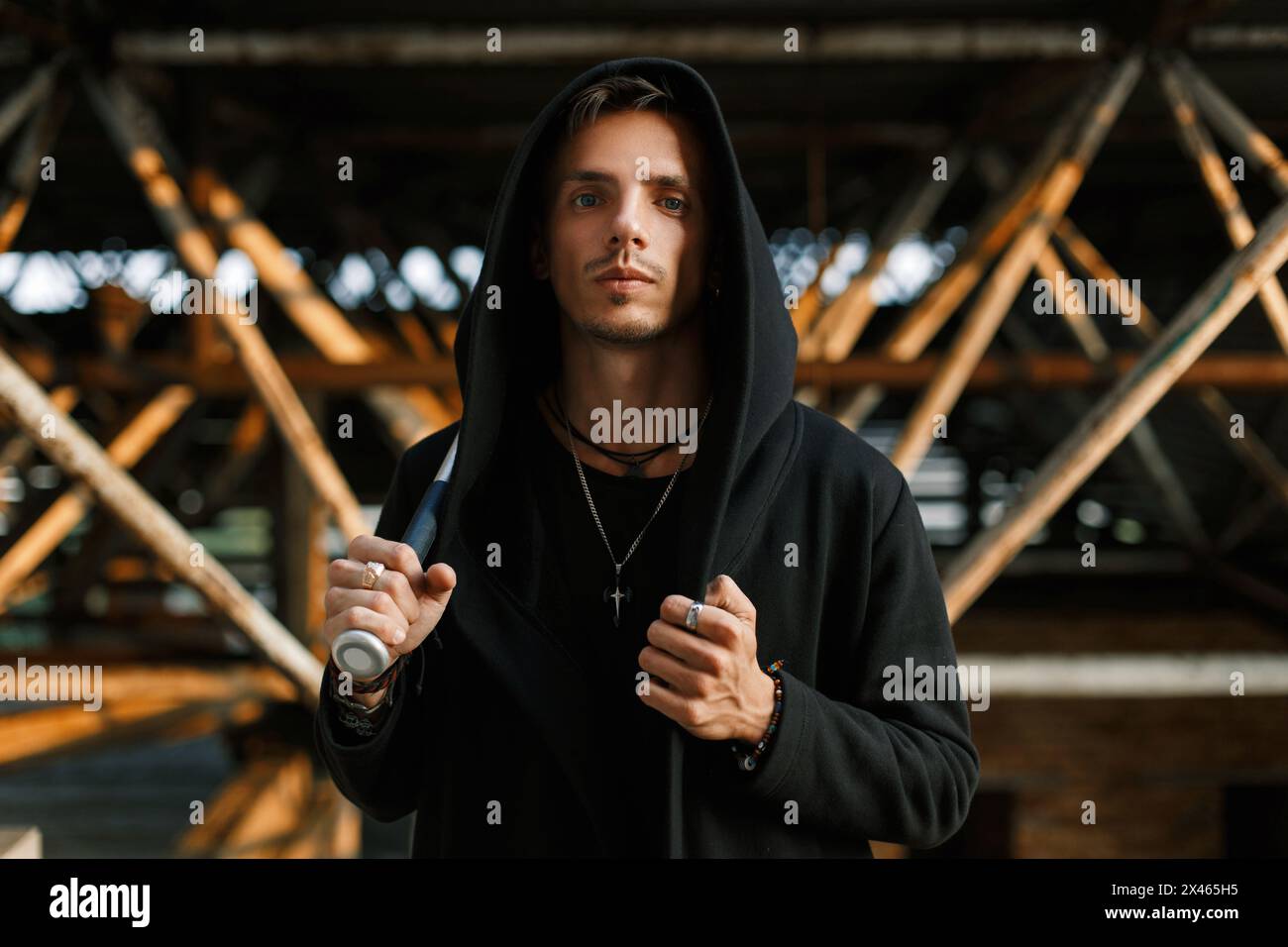 Stylish Handsome Man In A Black Robe With A Hood Holds A Bat Stock ...