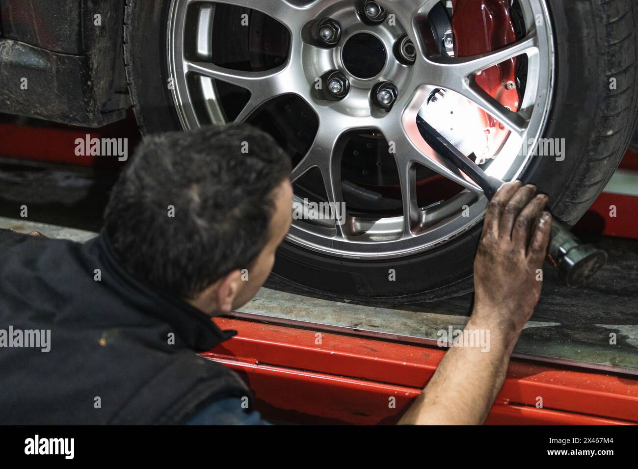 Back view of unrecognizable male auto mechanic with dirty hands ...