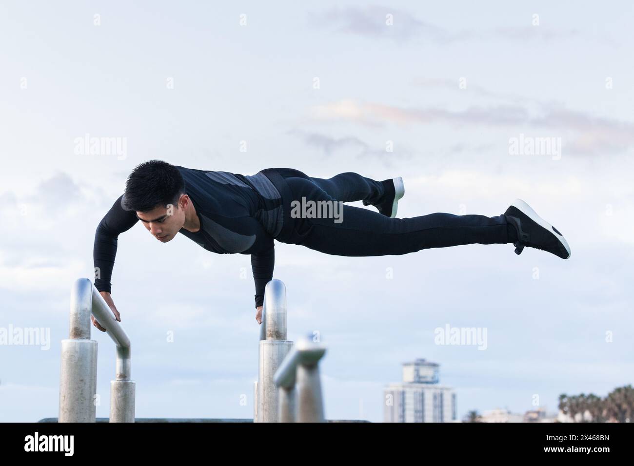 Low angle full body of confident young Asian male gymnast performing ...