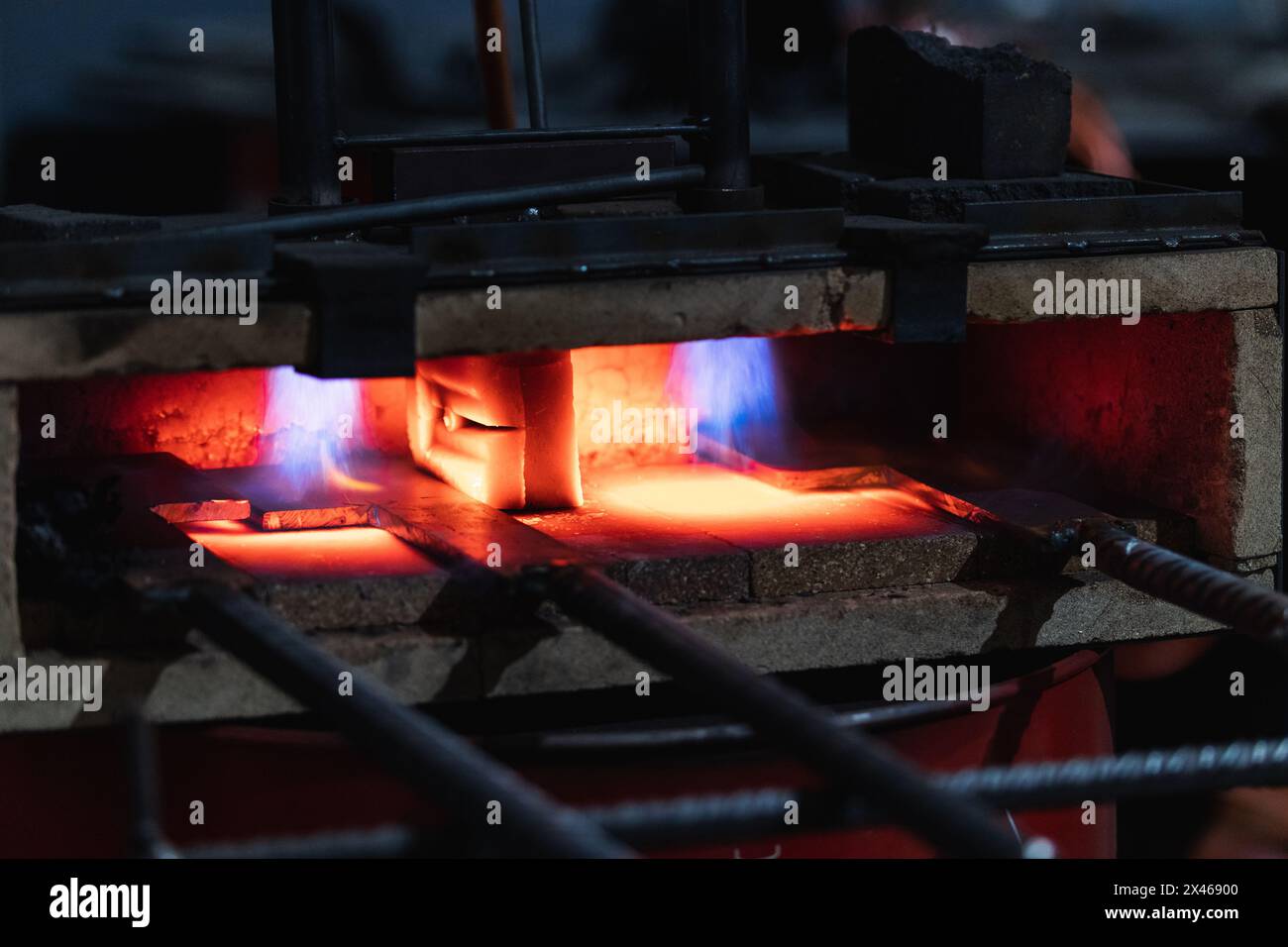 Burning metal tool in melting hot high temperature furnace of smelter ...