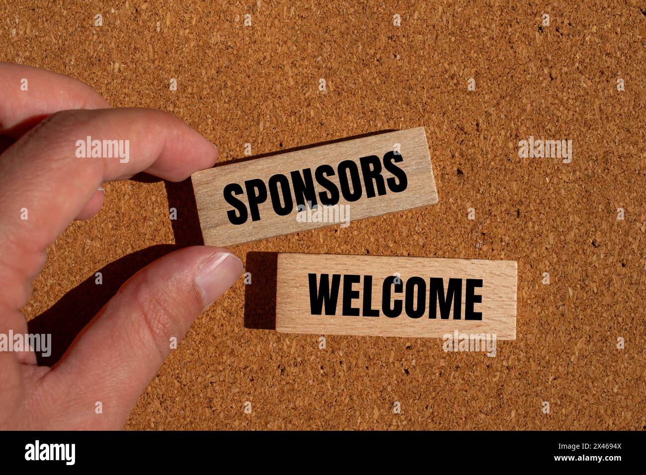 Sponsors welcome words written on wooden blocks with brown background ...