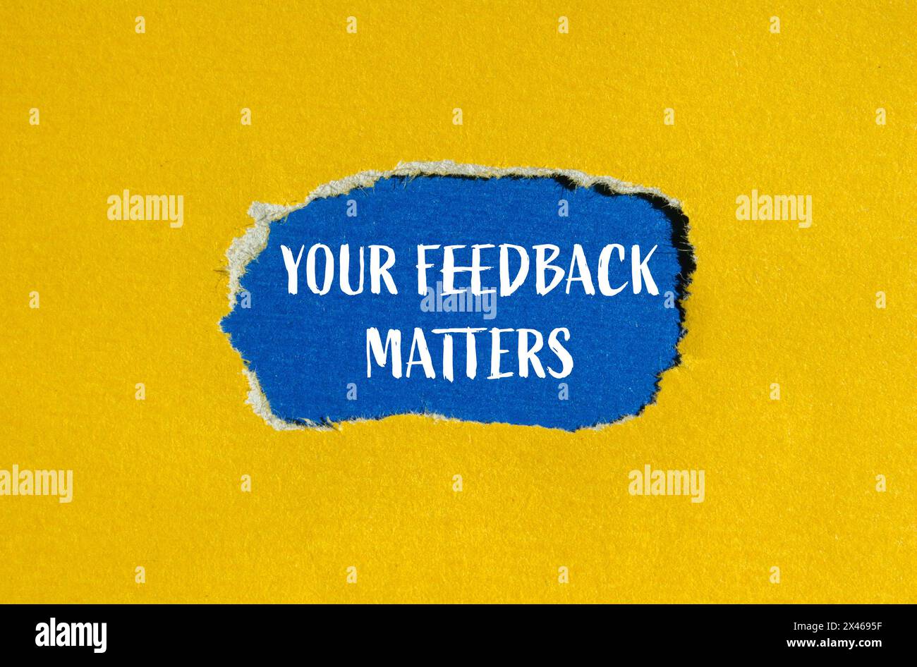 Your feedback matters written on ripped yellow paper with blue ...