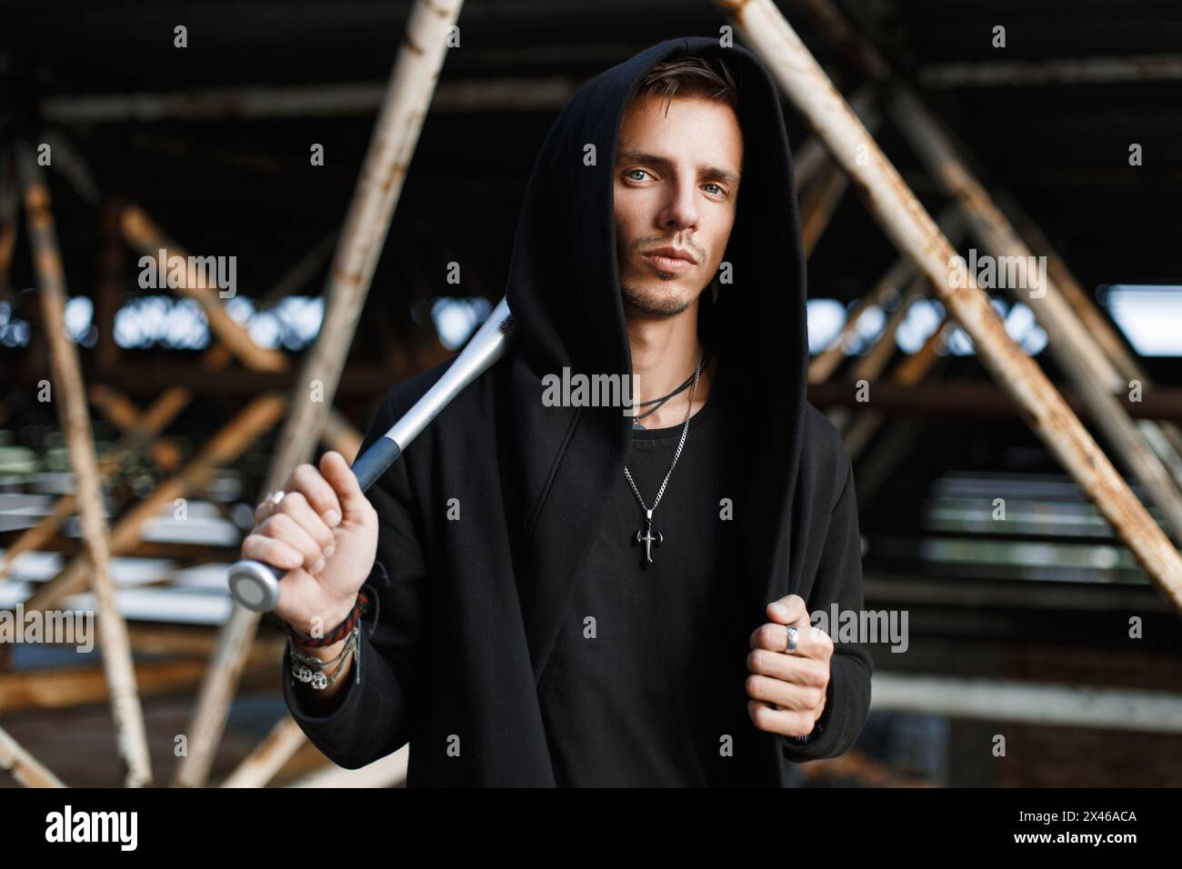 Angry Man In Black Clothes Holding A Bat On The Background Of Metal ...
