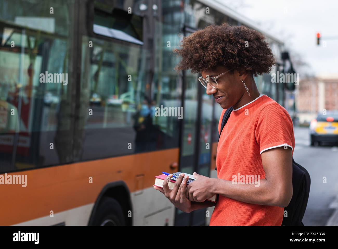 Side view of trendy young black male student with Afro hair in casual ...
