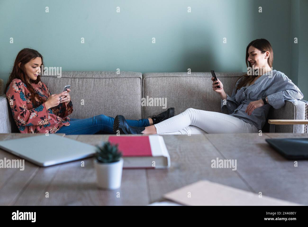 Full body side view young females in casual outfits resting on ...
