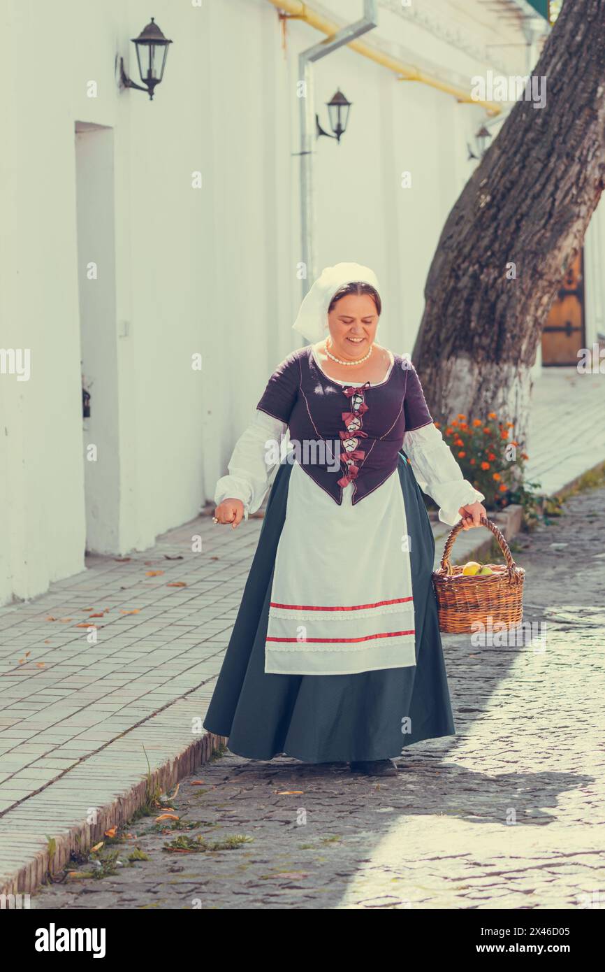Portrait of brunette woman dressed in historical Baroque clothes with ...
