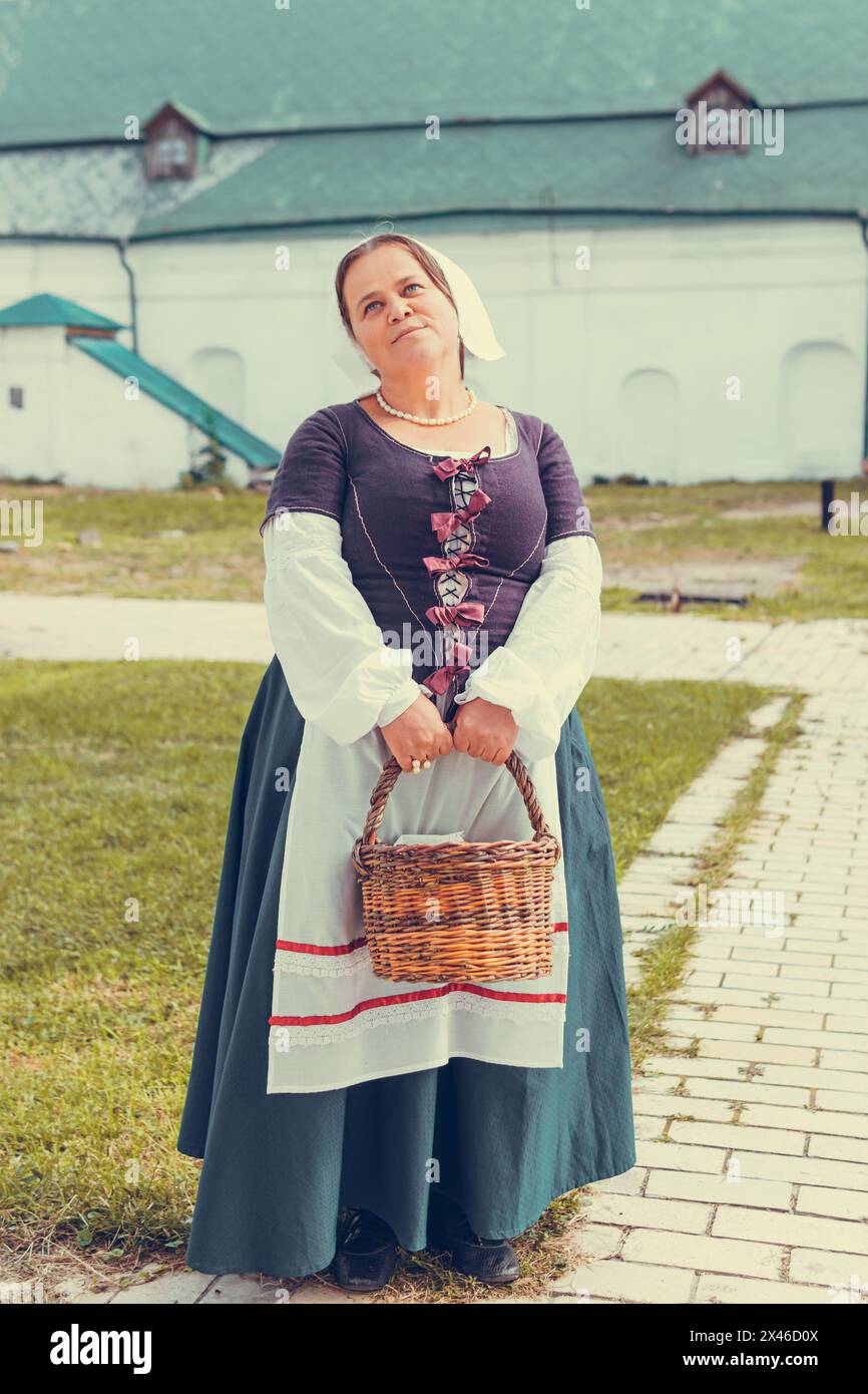 Portrait of brunette woman dressed in historical Baroque clothes with ...
