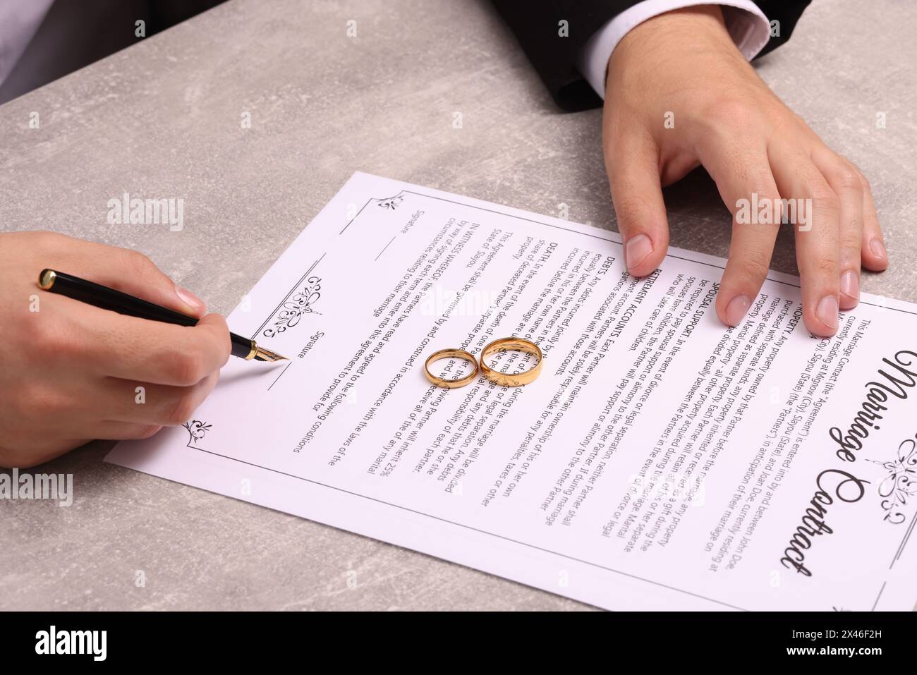 Man signing marriage contract at light grey table, closeup Stock Photo ...