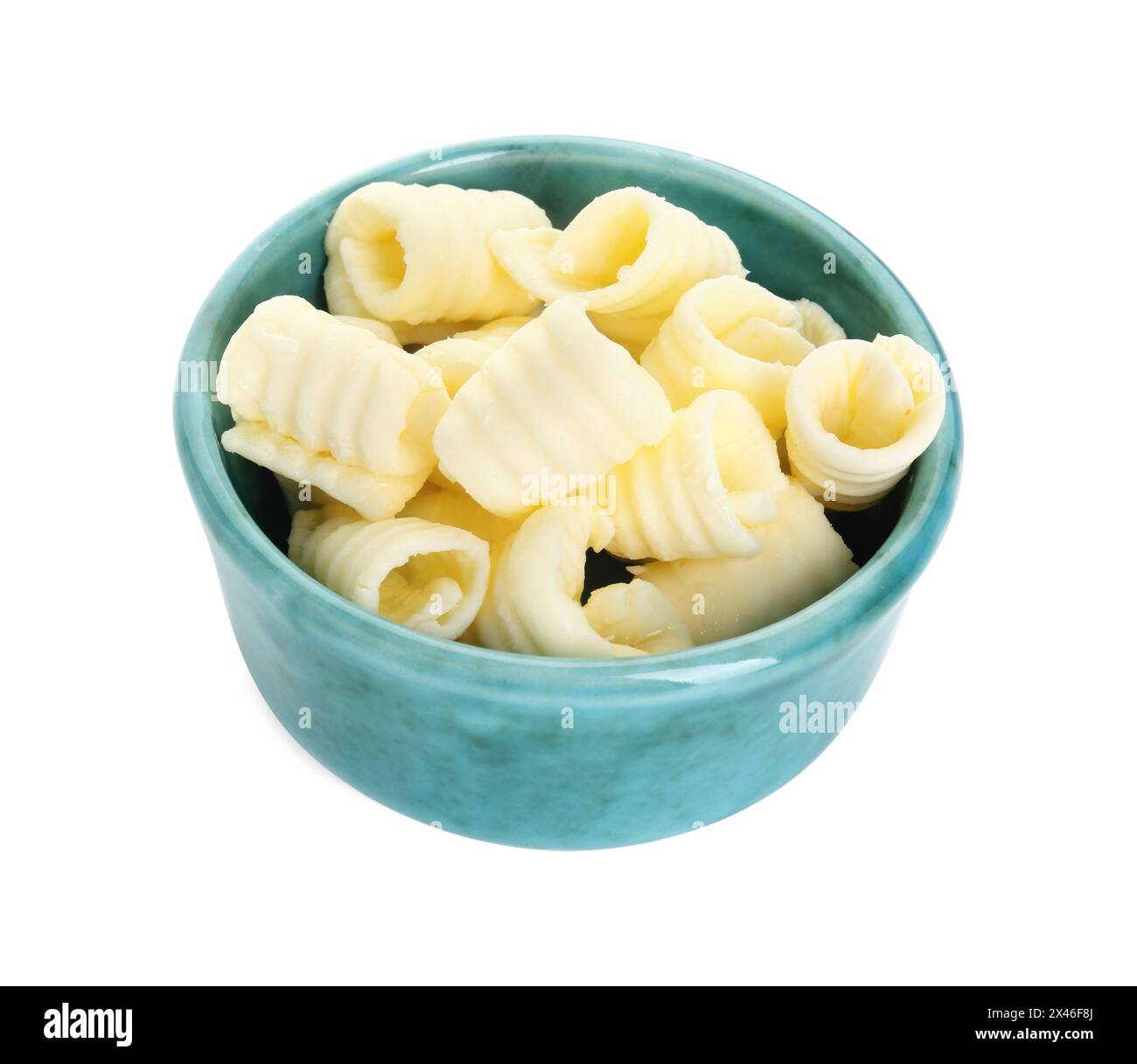 Tasty butter curls in bowl isolated on white Stock Photo - Alamy
