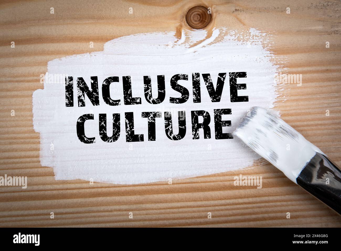 Inclusive Culture. White paint and paint brush on wood texture ...