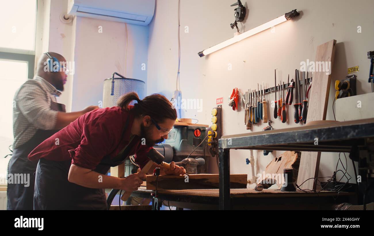 Woodworker using bench vise to hold lumber block, carving intricate ...
