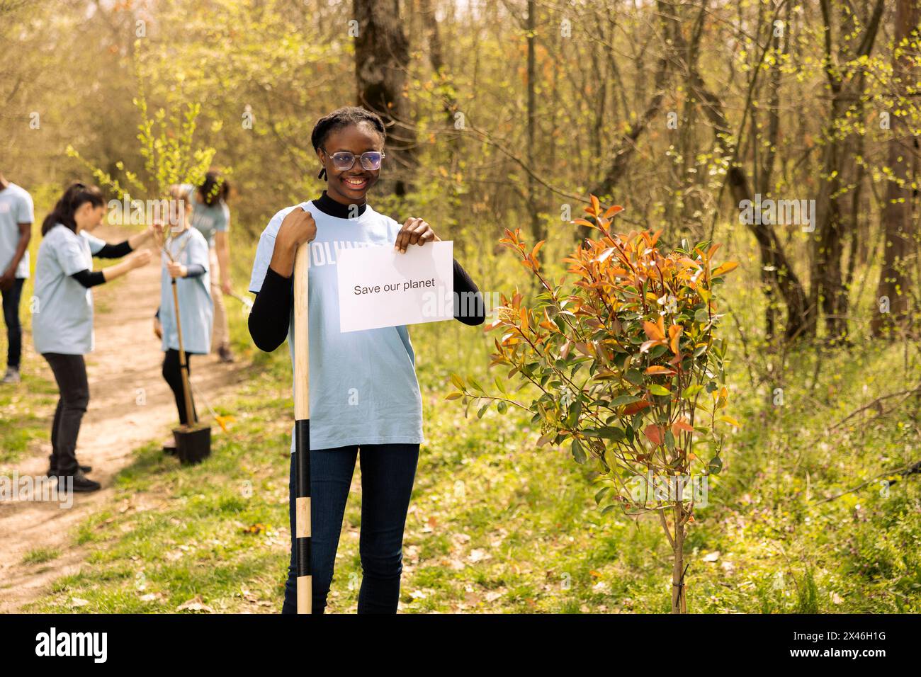 Portrait of african american girl holding banner with save our planet ...