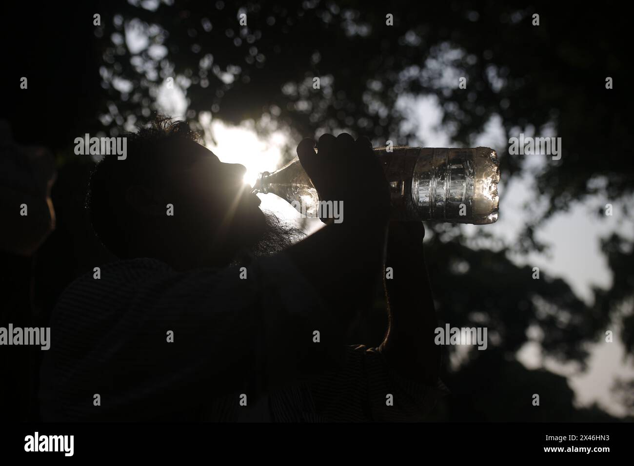 A man is drinking water to find relief from a heatwave in Dhaka ...