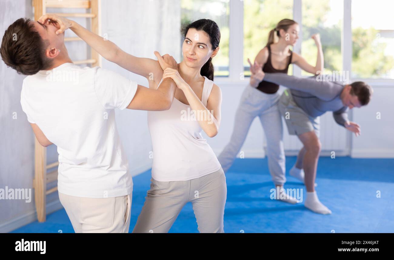 Young girl practicing self-defense techniques in pairs with guy Stock ...