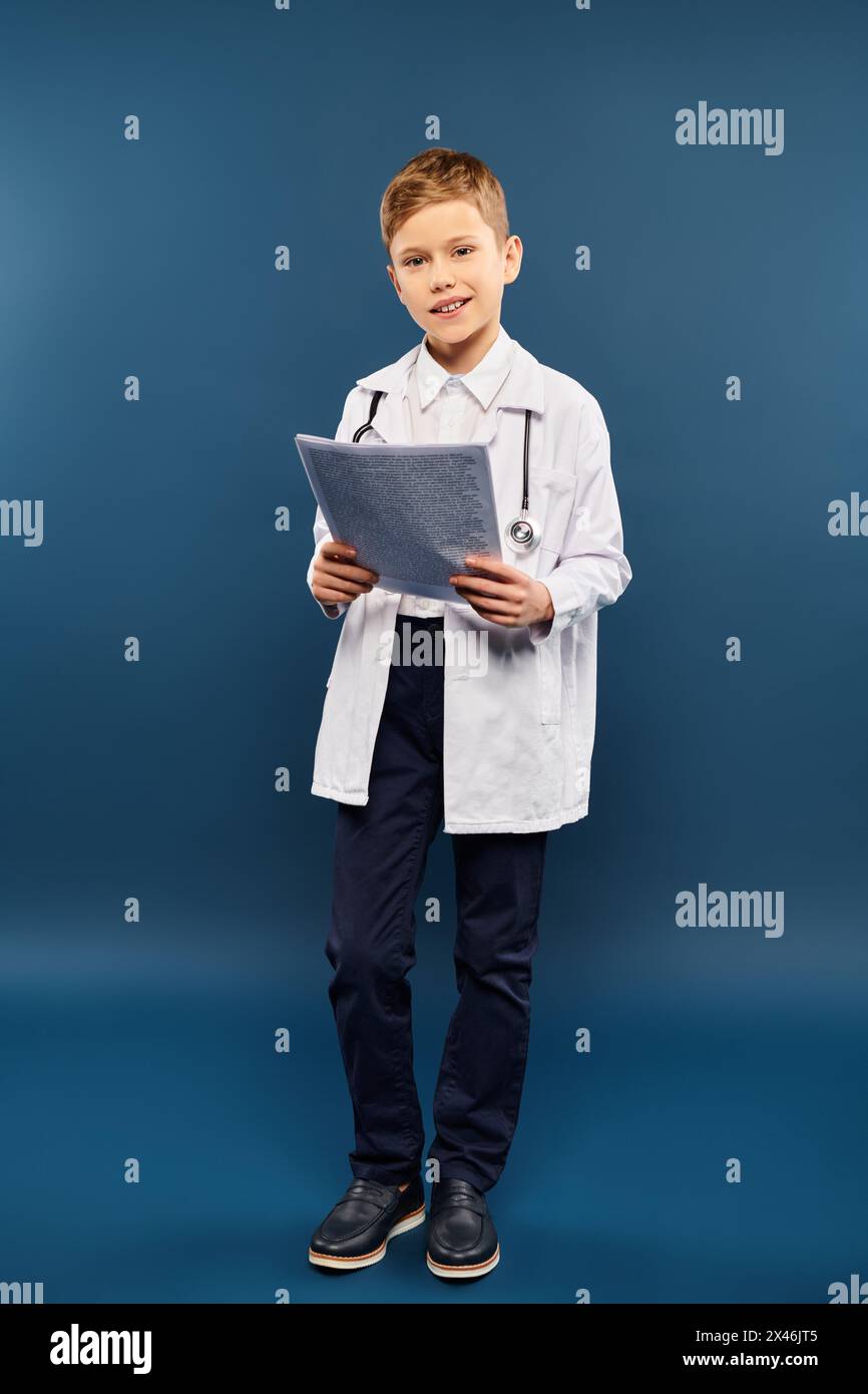A curious boy in a lab coat carefully inspects his clipboard Stock ...
