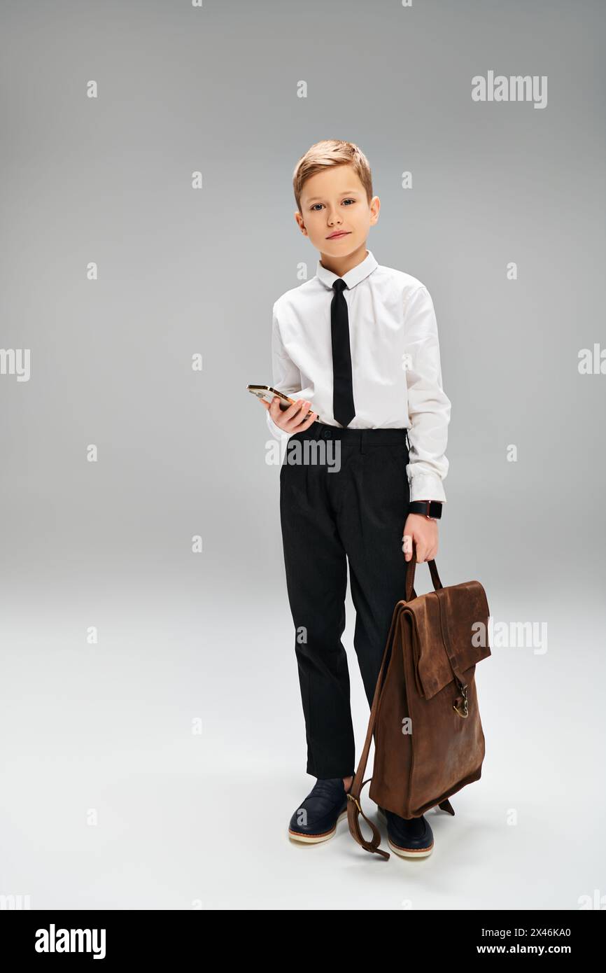 Preadolescent boy in white shirt and tie holds secretive brown bag ...