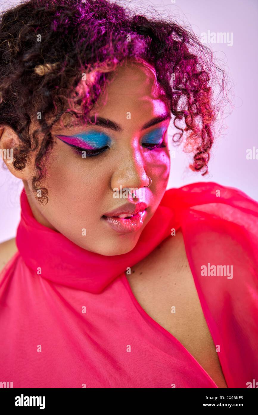 A beautiful African American woman poses actively in a pink dress with ...