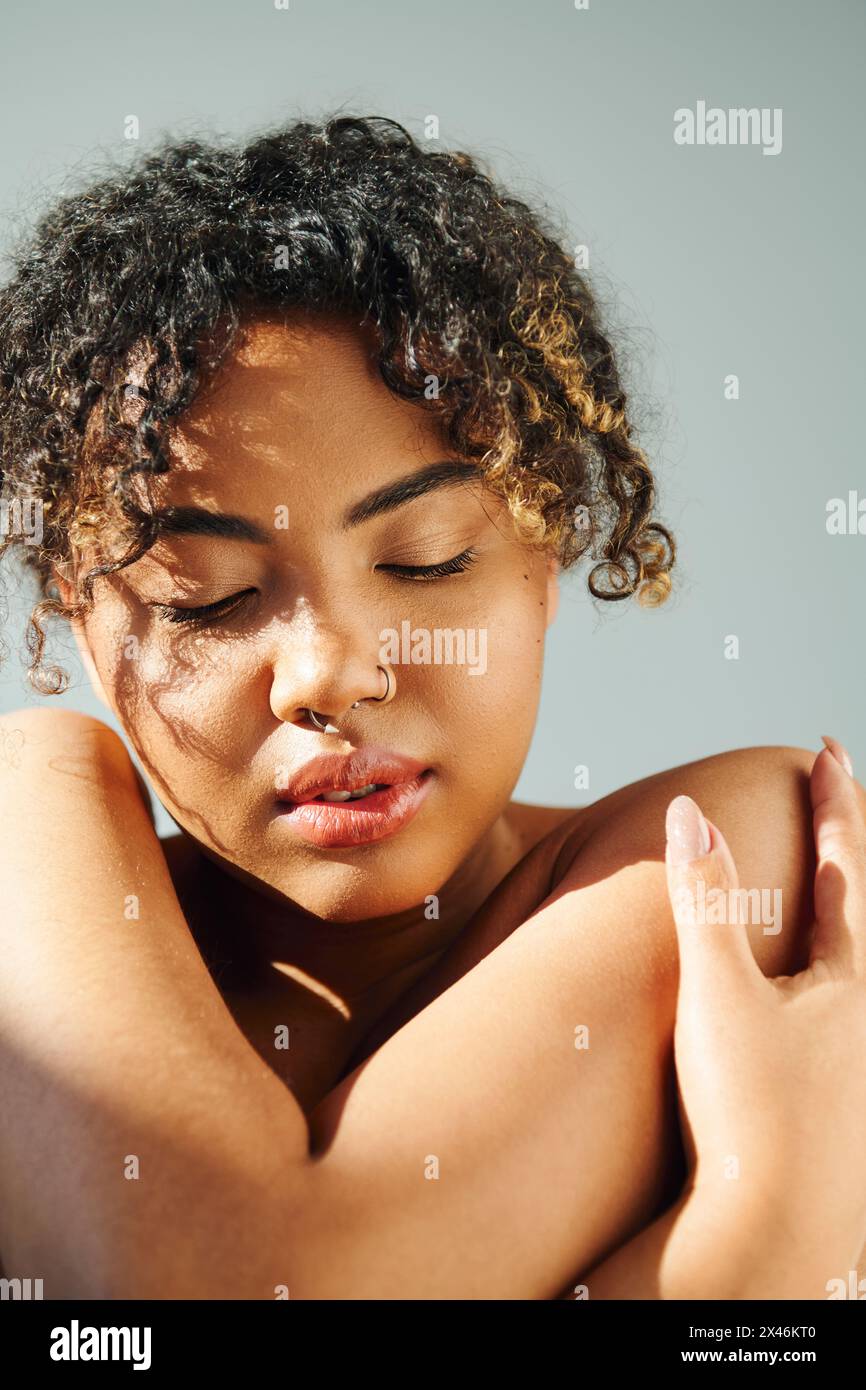 African American woman with hands on chest against colorful background ...