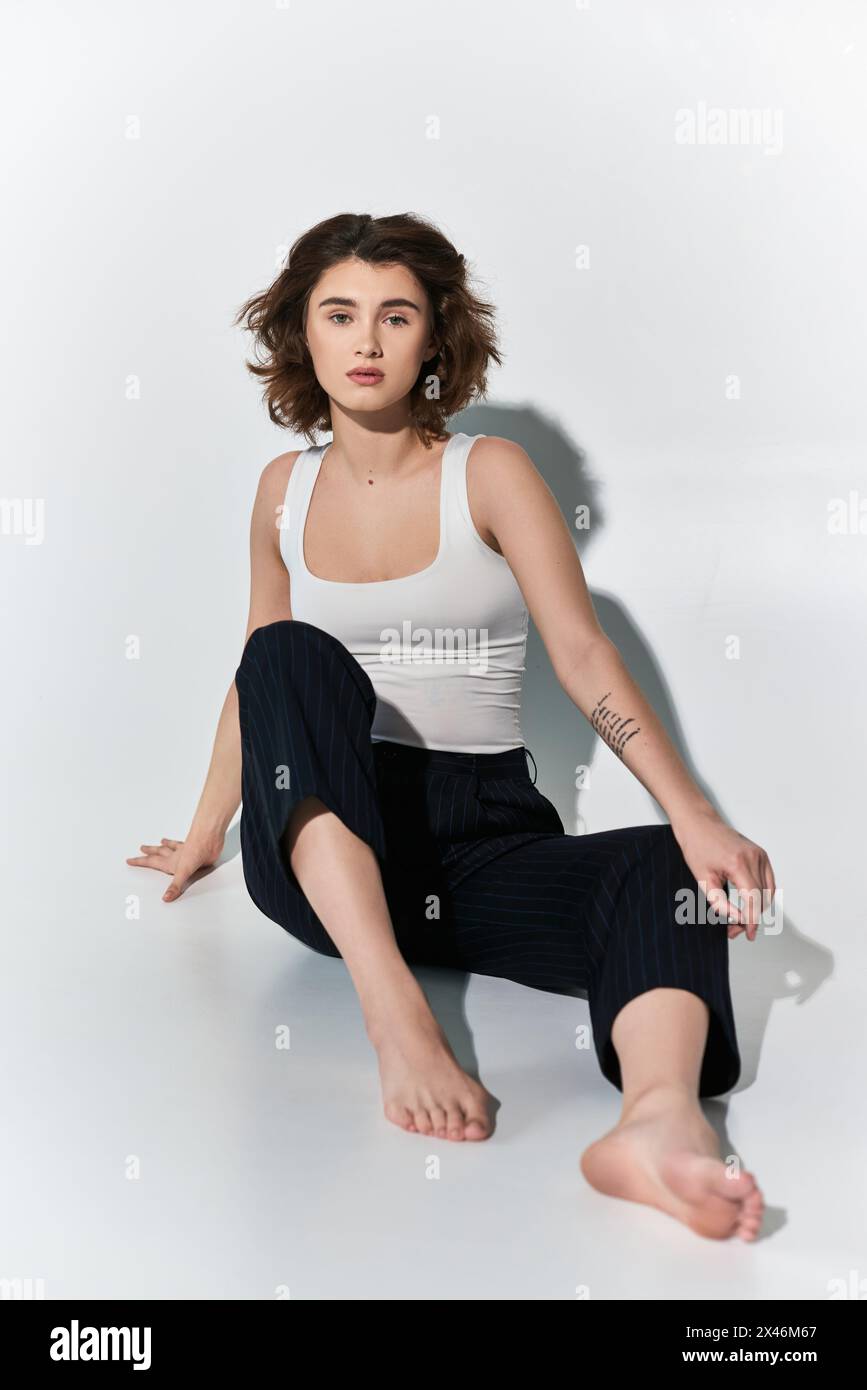 Young woman crossing legs model hi-res stock photography and images - Alamy