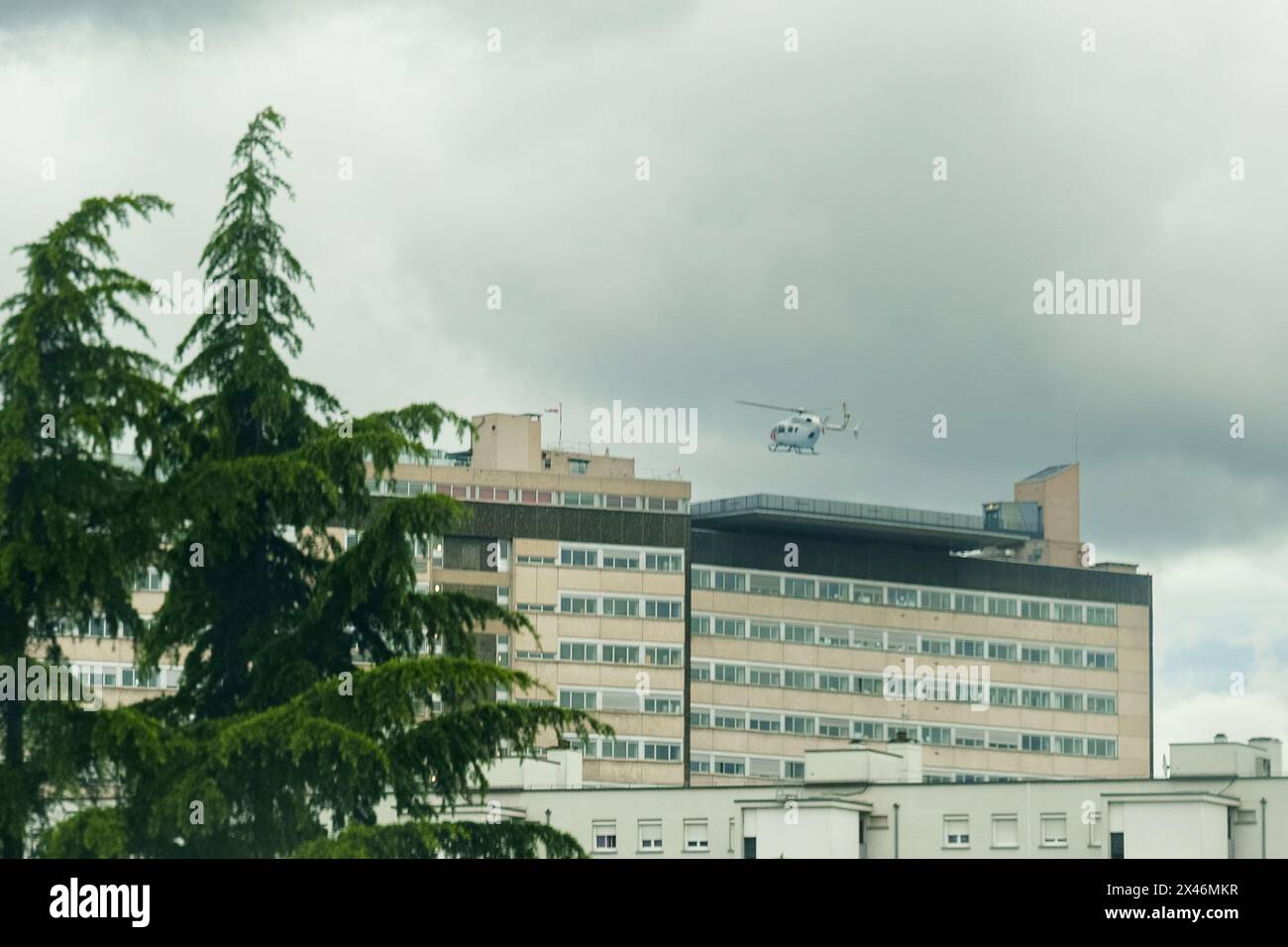 A plane is seen flying over a tall building, illustrating the contrast ...