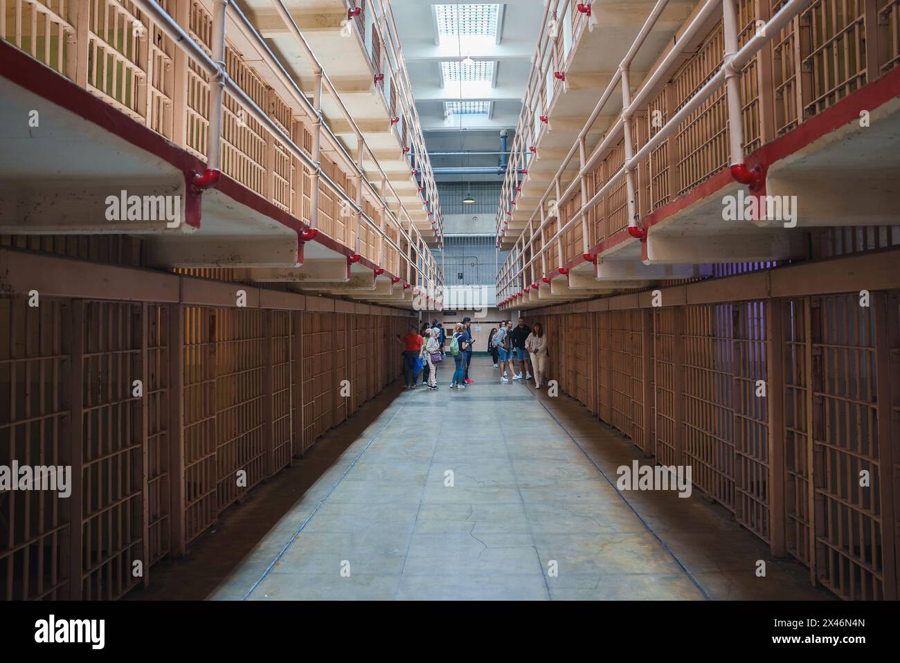 Alcatraz prison interior, long corridor with cell doors, visitors on ...